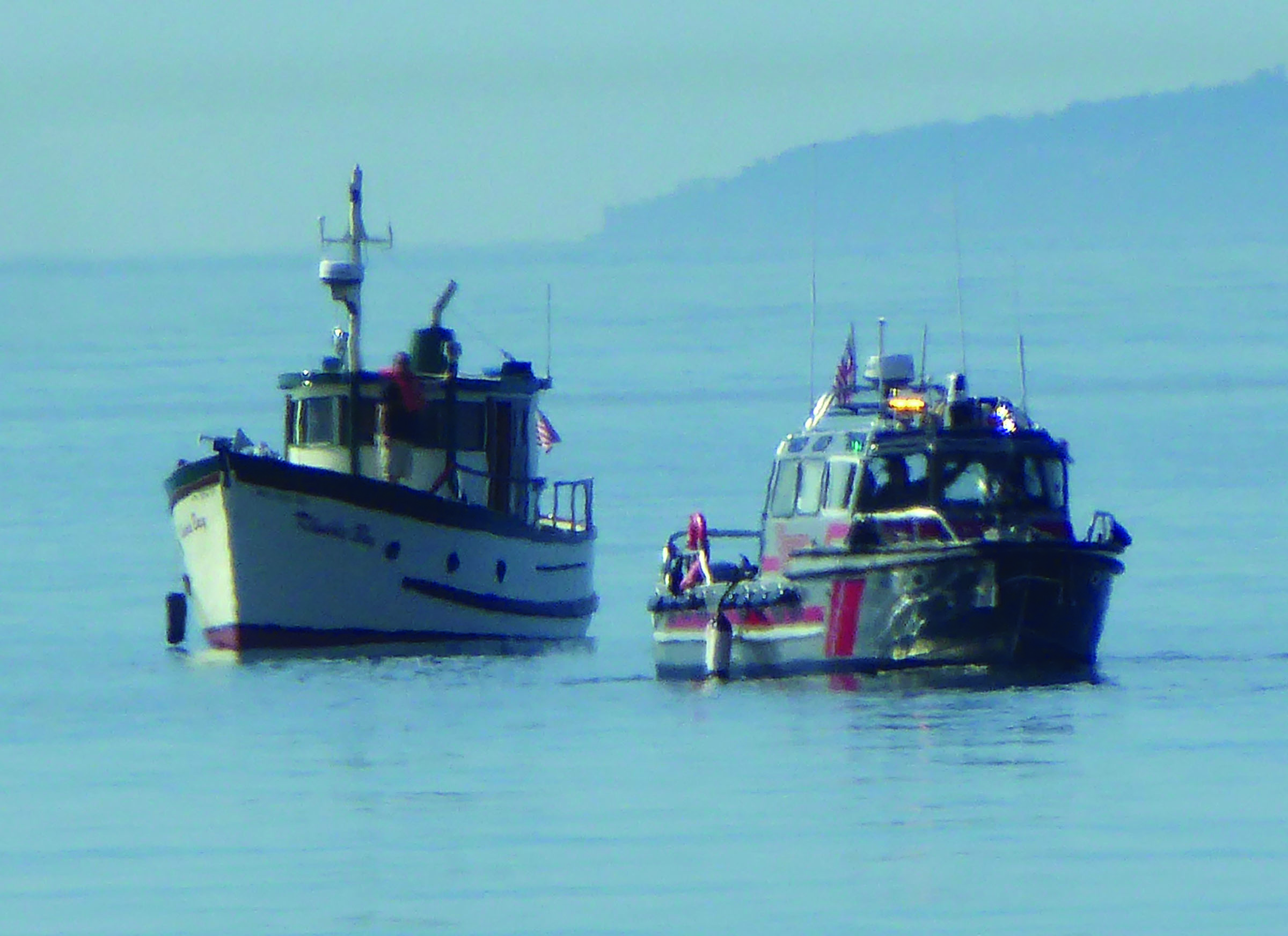 Six people rescued from boat after it catches fire in water near Port ...