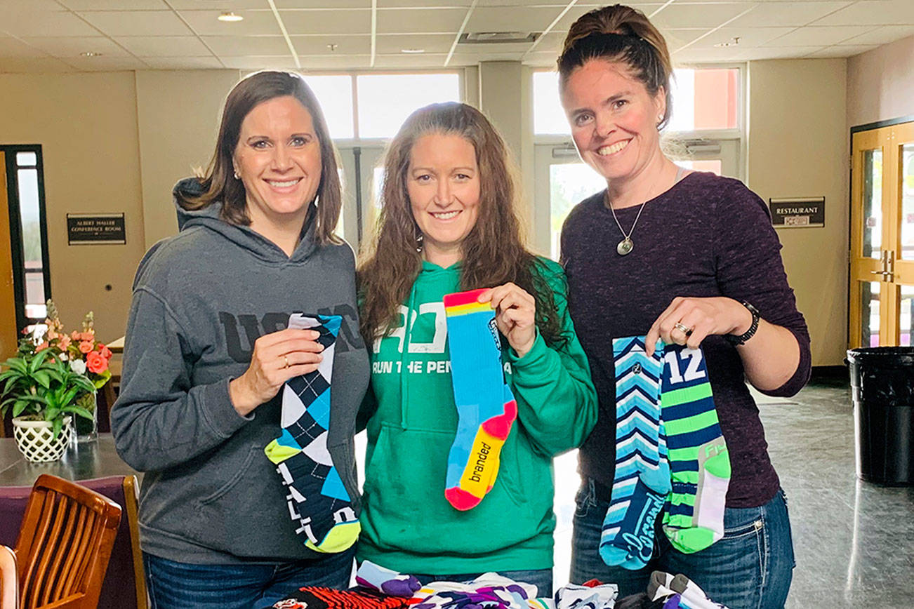 $1,000 worth of socks donated to Caring for Kids | Peninsula Daily News